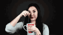 Girl Dipping Tea Bag And Looking Around GIF | GIFDB.com