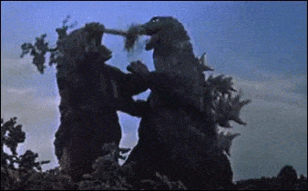 King Kong Shoving Tree Trunk In Godzilla's Mouth GIF | GIFDB.com