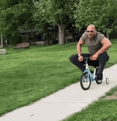Andrew Tate Riding Kids Bicycle GIF | GIFDB.com