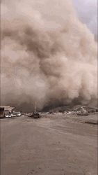Cloudy Dust Storm Moving Through Houses GIF | GIFDB.com