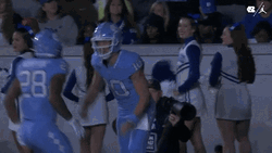Drake Maye Chest Bump With Groupmate GIF | GIFDB.com