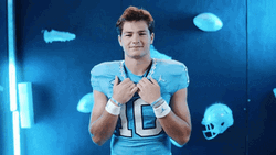 Drake Maye Holding Neckline Of Shirt GIF | GIFDB.com