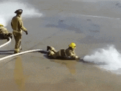Fireman Bring Pushed Back By Fire Hose GIF | GIFDB.com