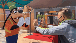 Goofy And Man High Five In Disneyland GIF | GIFDB.com
