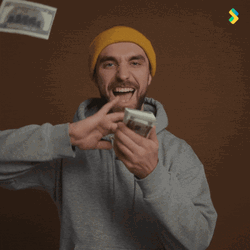 Guy In Gray Hoodie Shoving Cash Spend Money GIF | GIFDB.com