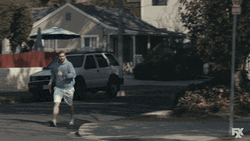 Guy Walking Fast On Roadside GIF | GIFDB.com