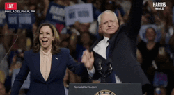 Harris Walz Hold Hand Waiving GIF | GIFDB.com