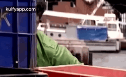 Man Behind The Containers Hiding Meme GIF | GIFDB.com