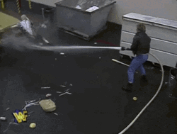 Man Splashing Water Using Fire Hose GIF | GIFDB.com