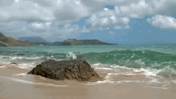 Ocean Waves Against Small Rock GIF | GIFDB.com