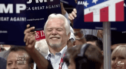 Old Man In Crowd Making Awkward Smile GIF | GIFDB.com