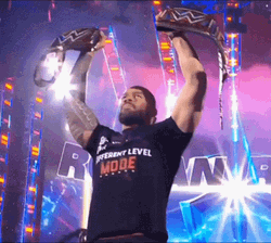 Roman Reigns Raises 2 Champions Belt GIF | GIFDB.com
