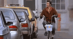 Seinfeld Kramer Giddy Up Salute While Riding Bike GIF | GIFDB.com