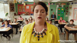Teacher Smiling In Classroom GIF | GIFDB.com