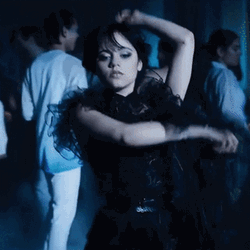 Wednesday Addams Arm Roll Dancing GIF | GIFDB.com